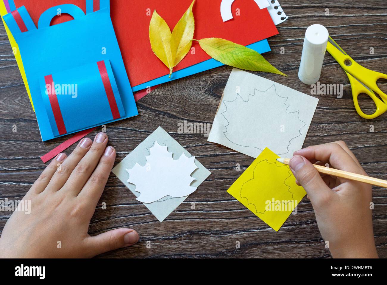 Instruction step 7. Greeting card paper backpack on a wooden table ...