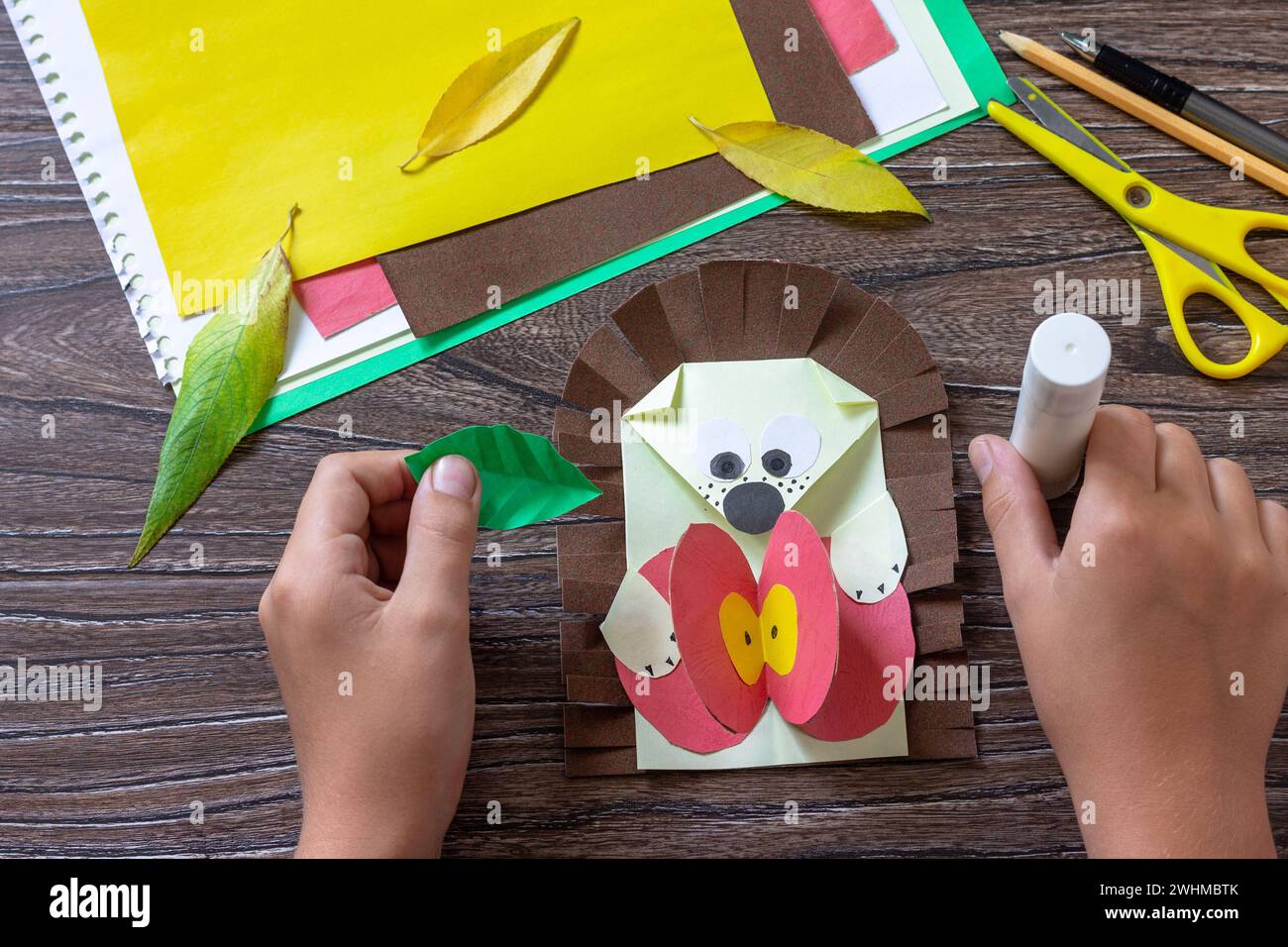 Instruction step 10. Postcard hedgehog with an apple on a wooden table ...