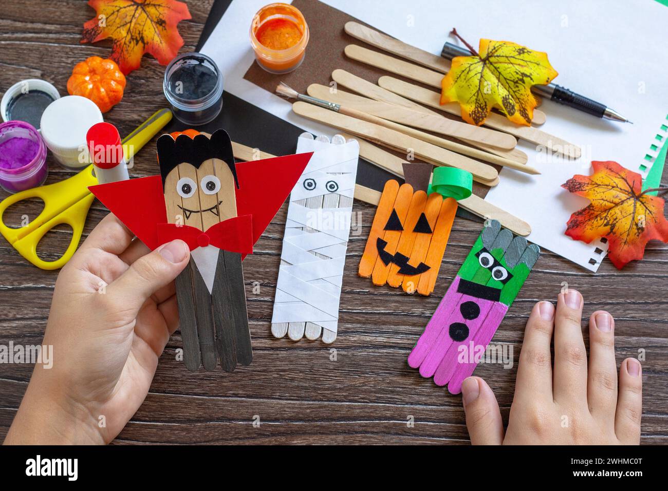 Child is holding Halloween ghost and vampire toy gift stics puppets on ...