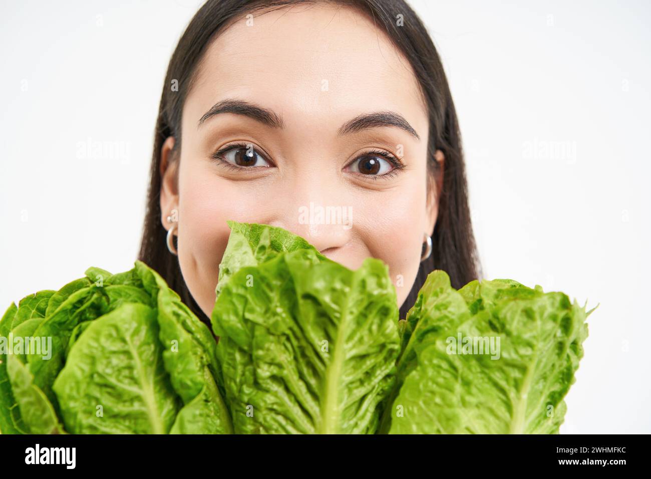Close Up Portrait Of Happy Korean Woman Shows Her Face With Lettuce Eating Cabbage Likes