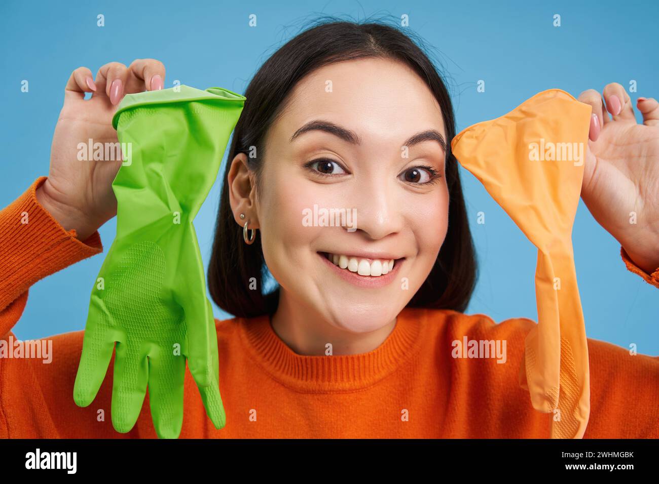 Close up portrait of smiling asian woman, showing two different latex ...