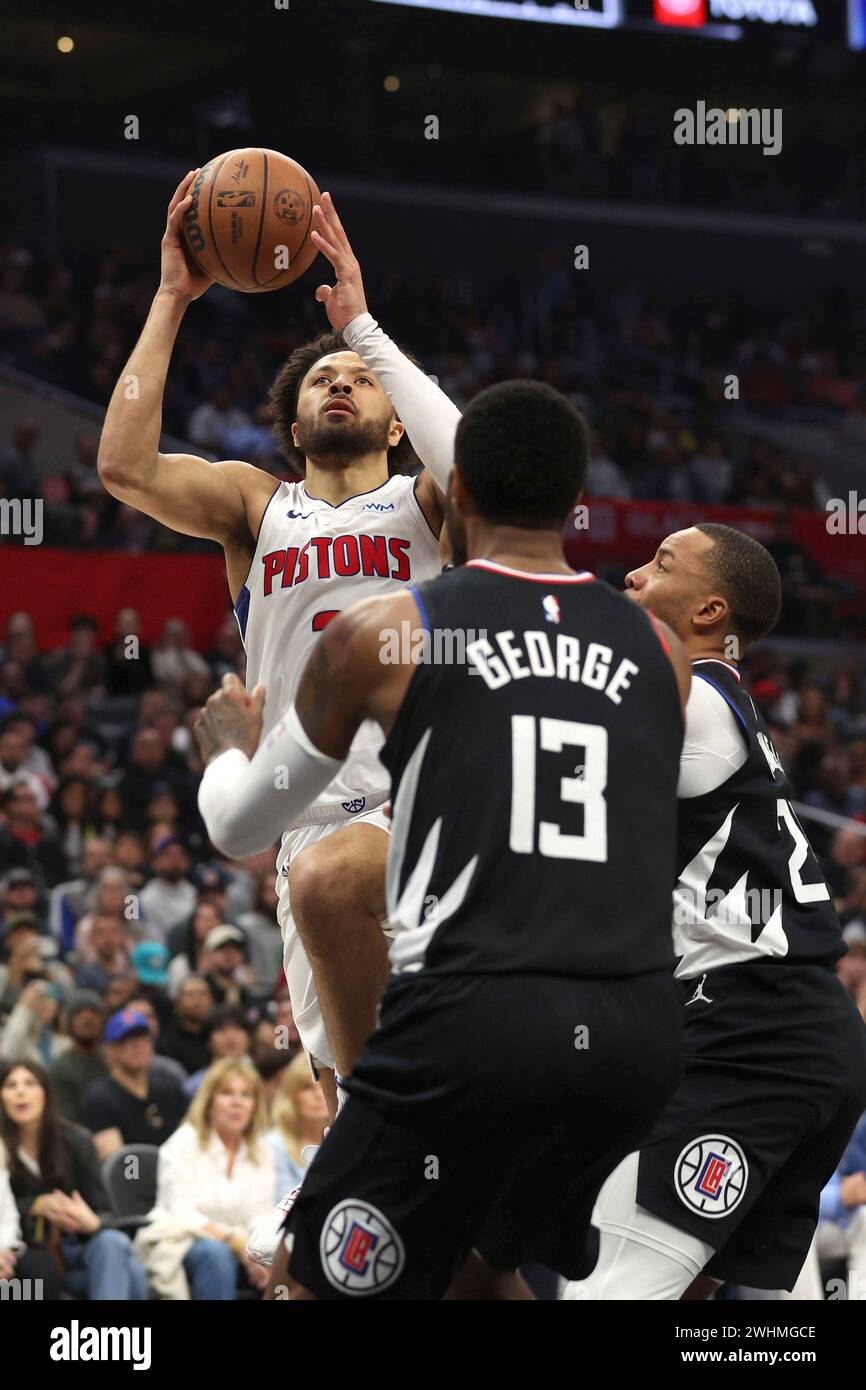 Detroit Pistons guard Cade Cunningham, left, attempts a layup defended ...