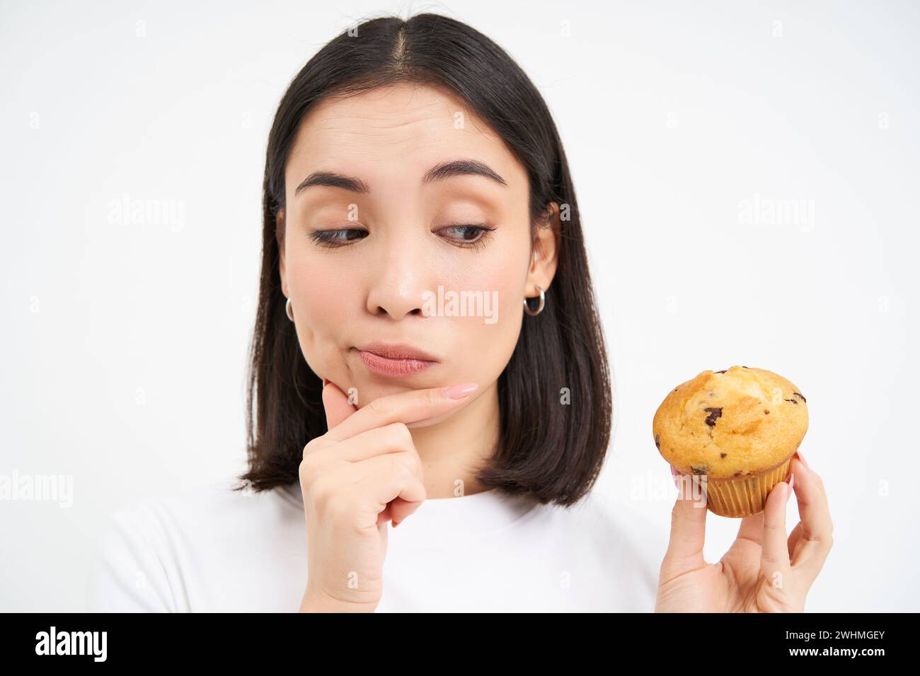 Close up portrait of asian woman with pensive smiling face, holds ...