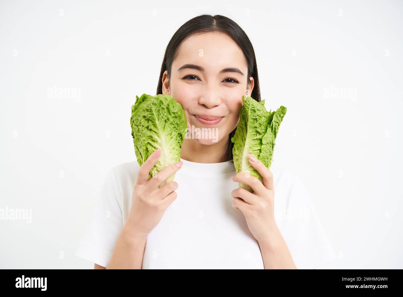 Happy korean woman vegetarian, smiling and showing cabbage, eating ...