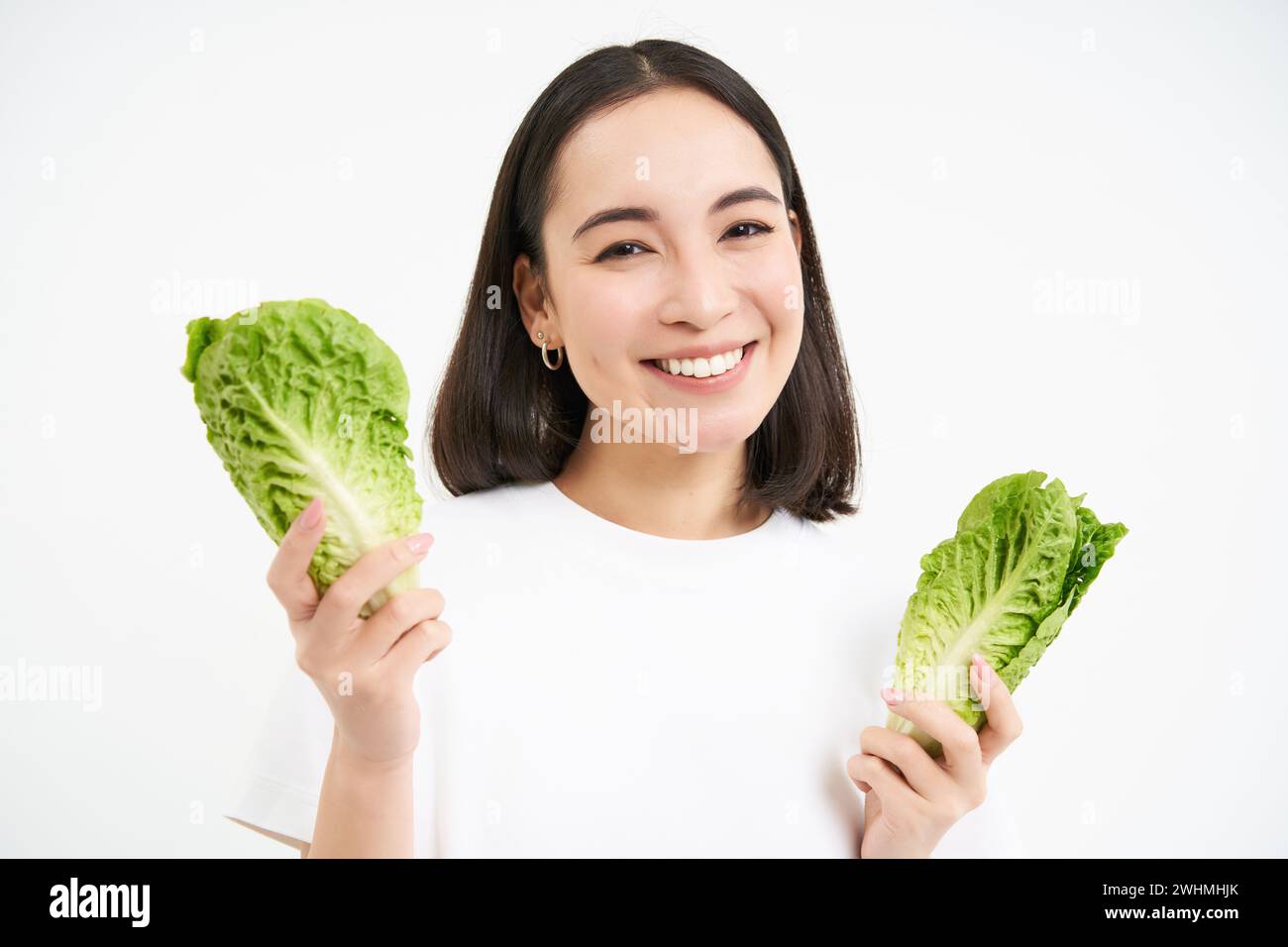 Happy korean woman vegetarian, smiling and showing cabbage, eating ...