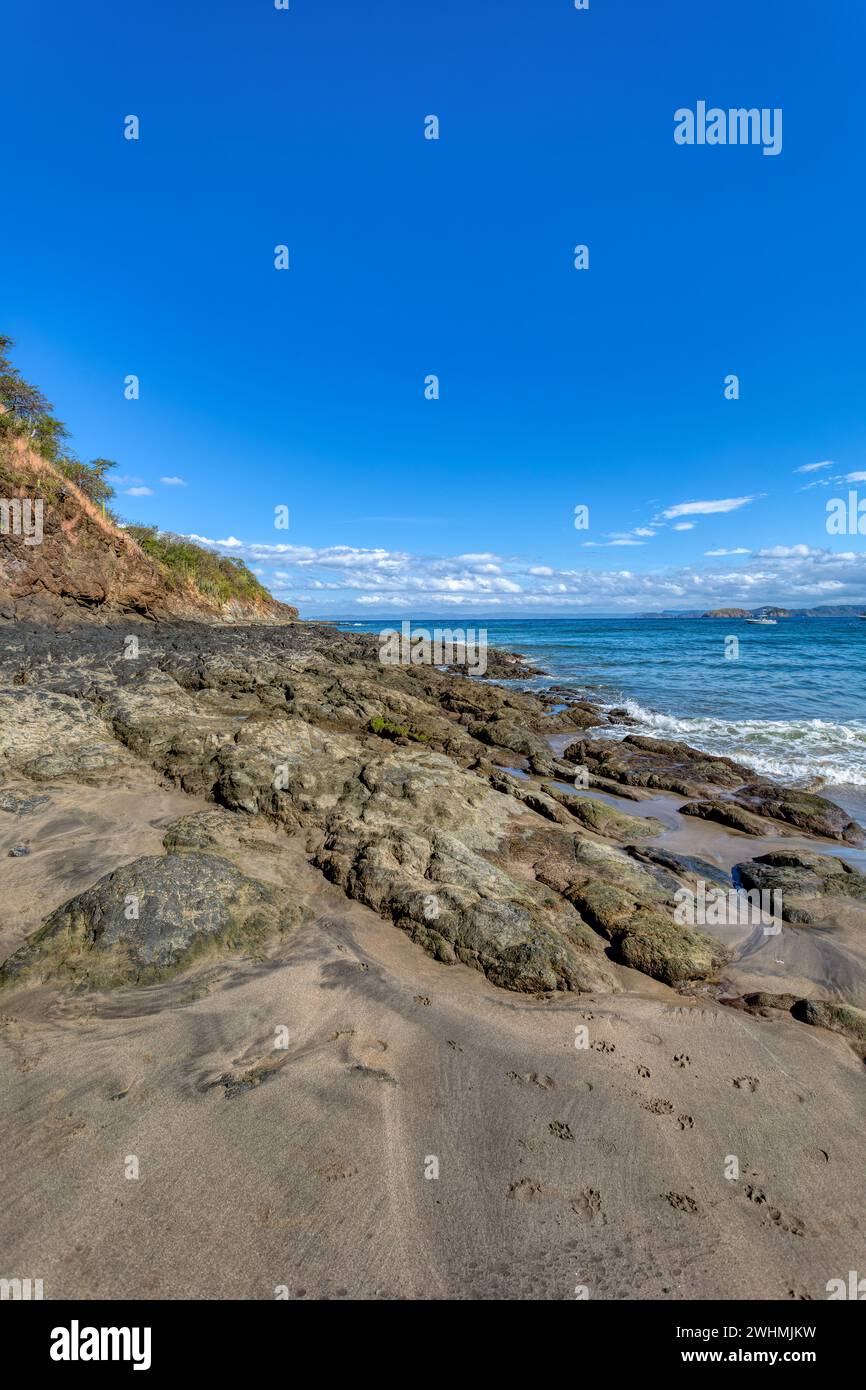Playa Ocotal and Pacific ocean waves on rocky shore, El Coco Costa Rica ...