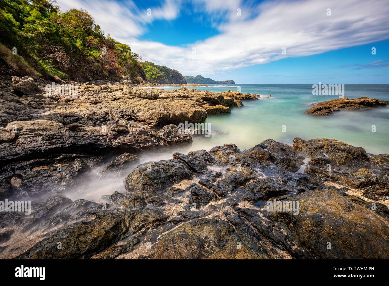 Long exposure, pacific ocean waves on rock in Playa Ocotal, El Coco ...