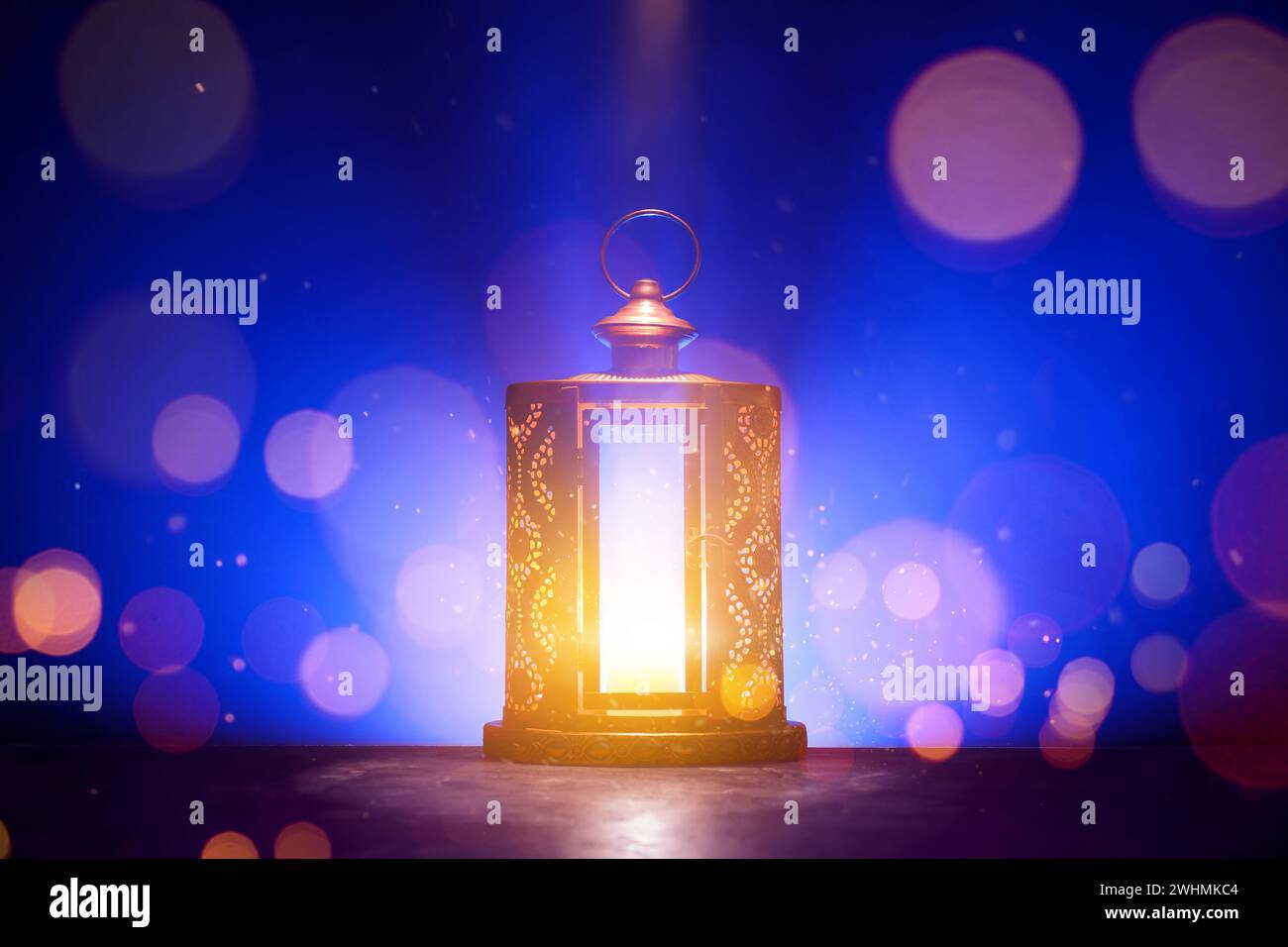 Arabic lamp on table against blue background with blurred lights Stock ...