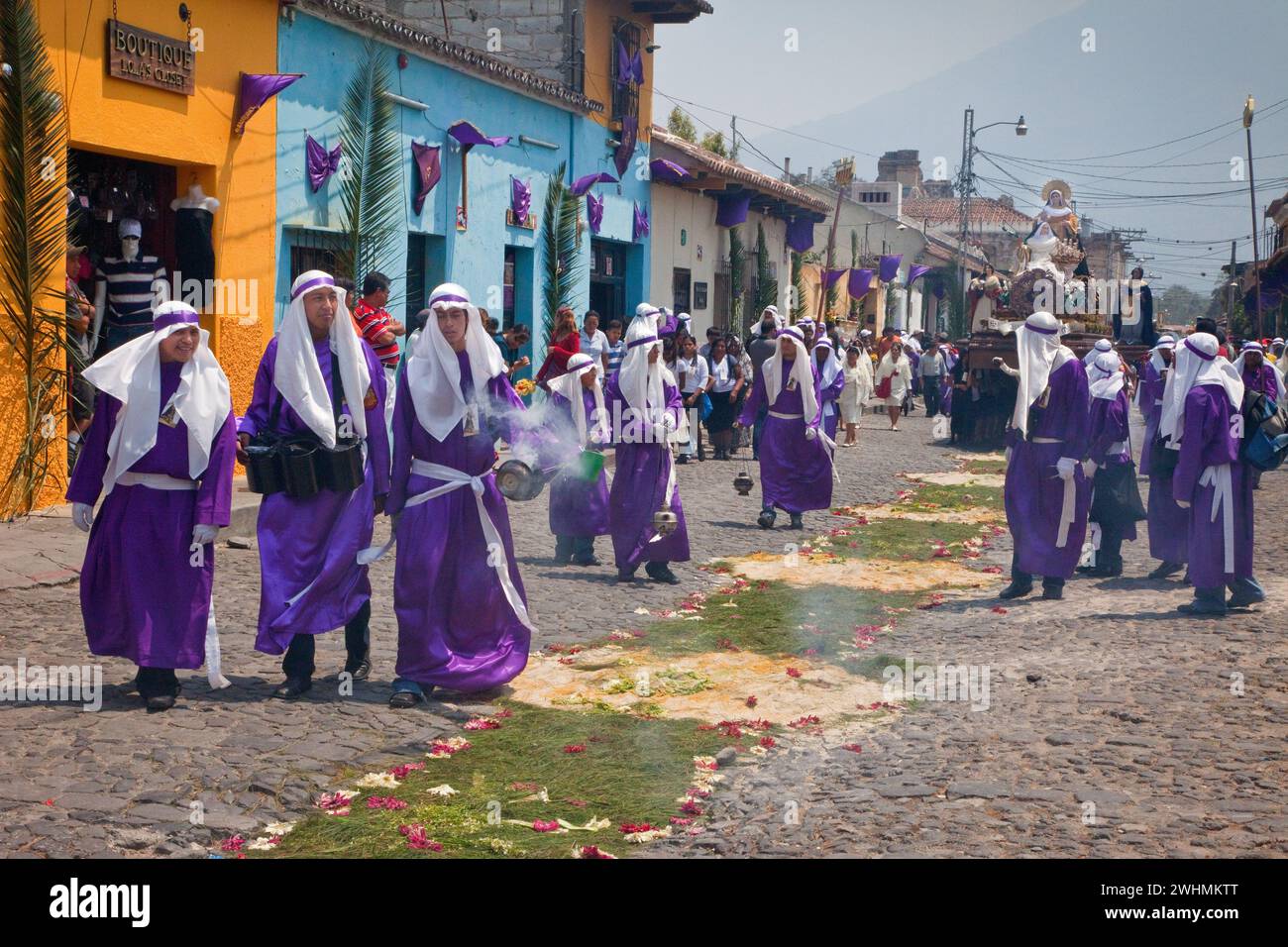 Antigua, Guatemala. Cucuruchos waving incense lead the way ahead of a ...
