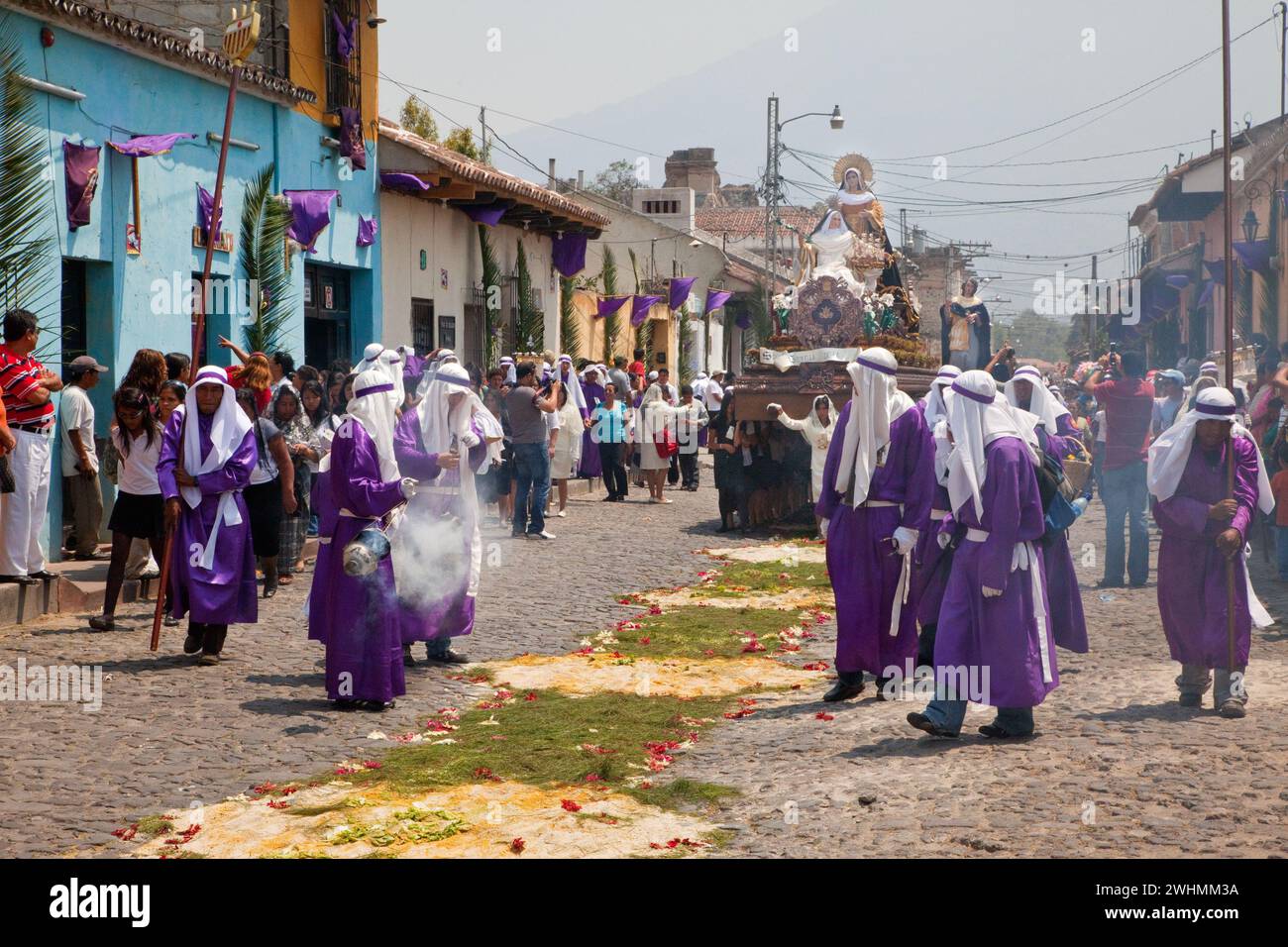 Antigua, Guatemala. Cucuruchos waving incense lead the way ahead of a ...