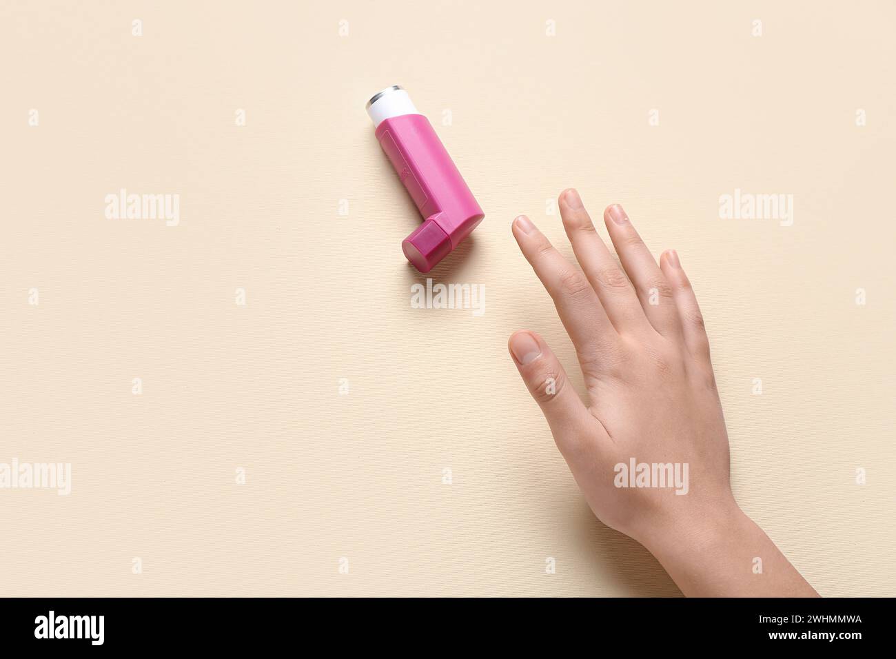 Child's hand with asthma inhaler on beige background Stock Photo - Alamy
