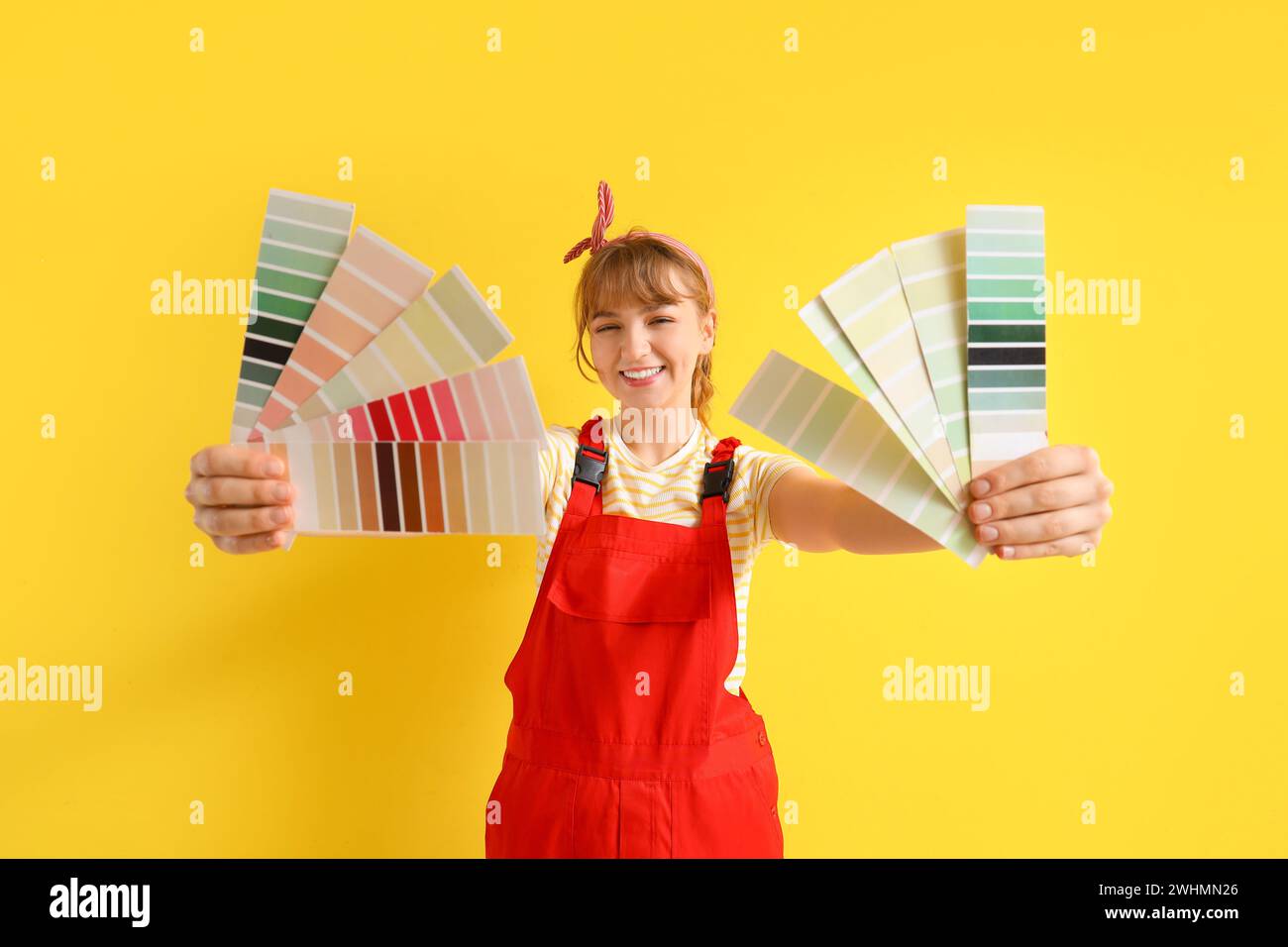 Female decorator with paint color palettes on yellow background Stock ...