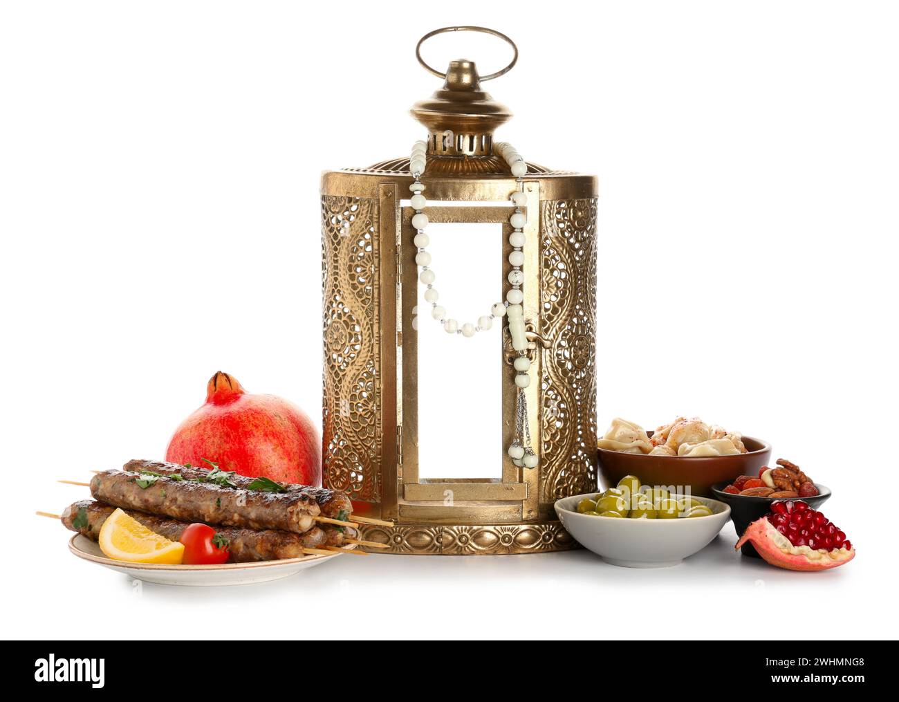 Traditional Eastern dishes and Muslim lantern on white background ...