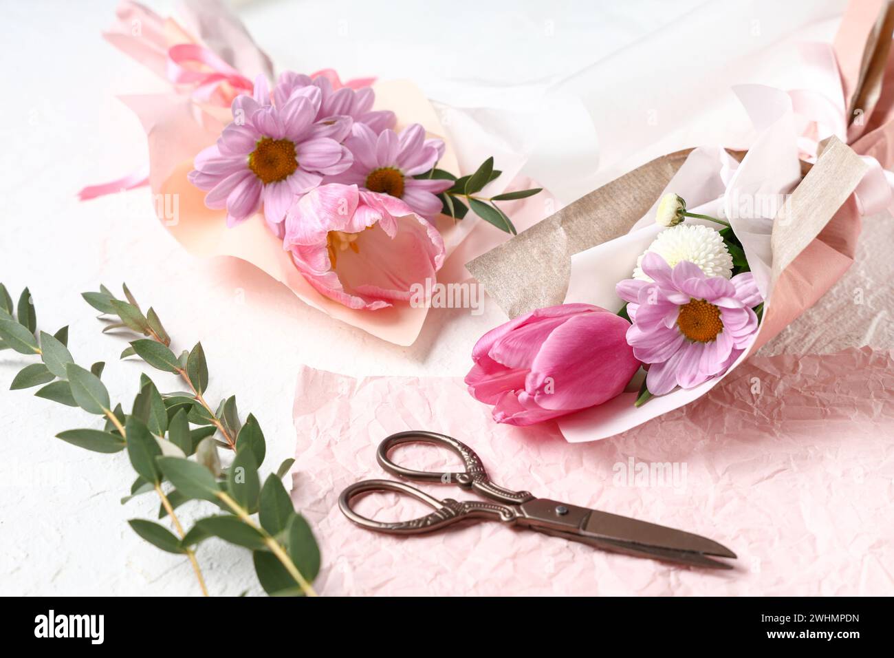 Mini bouquets of beautiful spring flowers in wrapping paper with ...