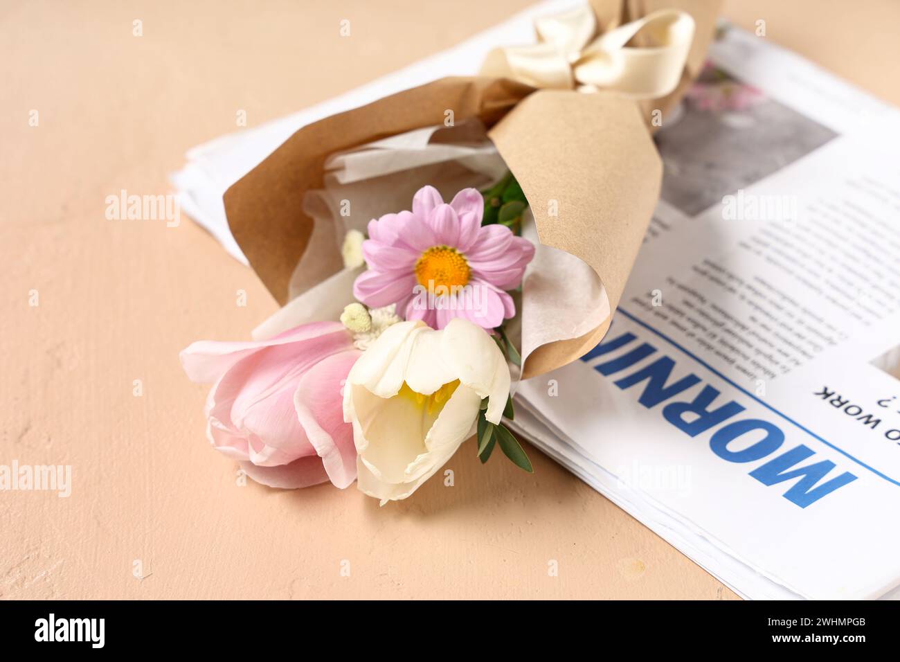 Mini bouquet of beautiful spring flowers in wrapping paper with ...