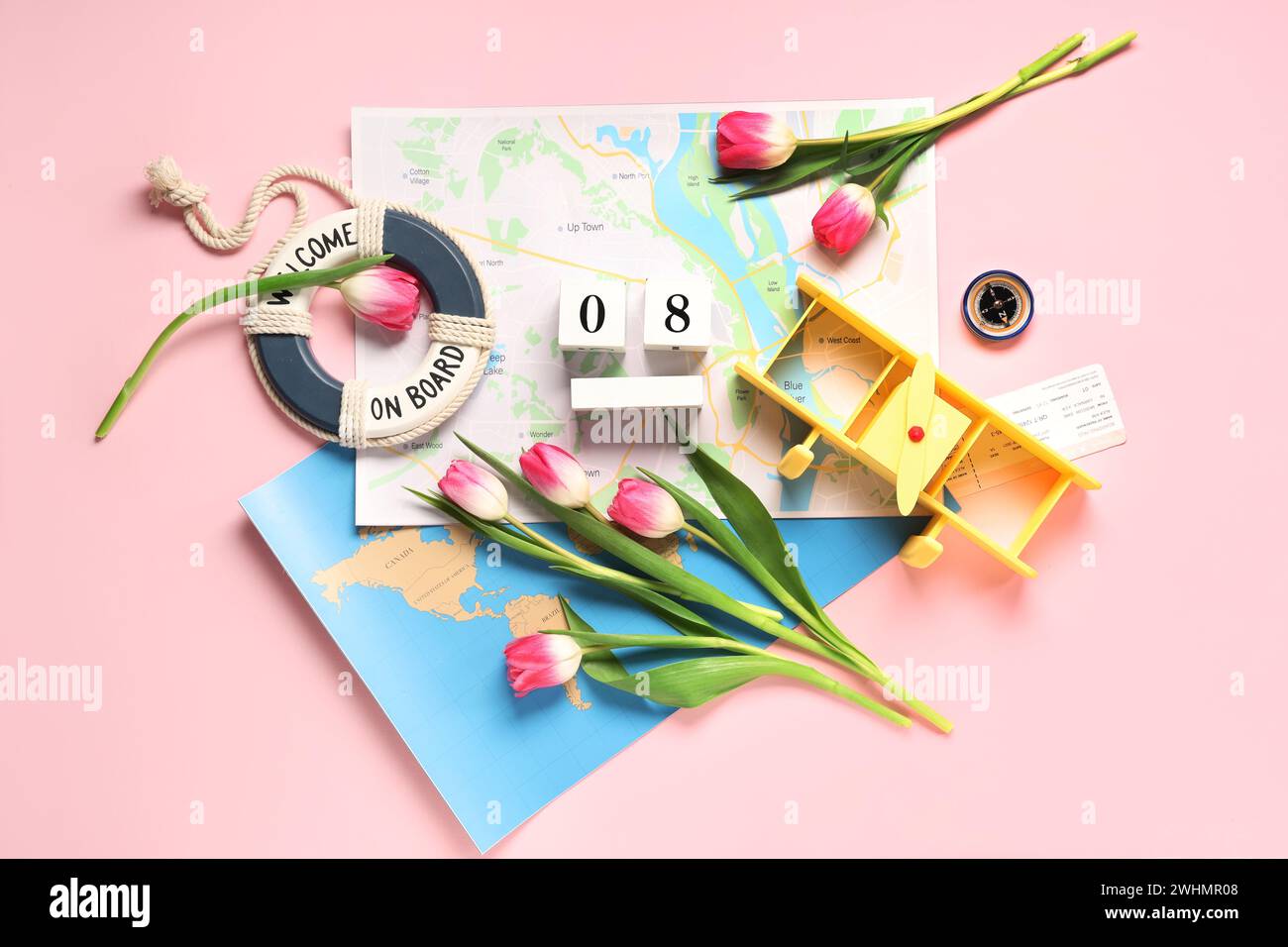 Composition with world maps, toy plane, ticket and flowers for ...