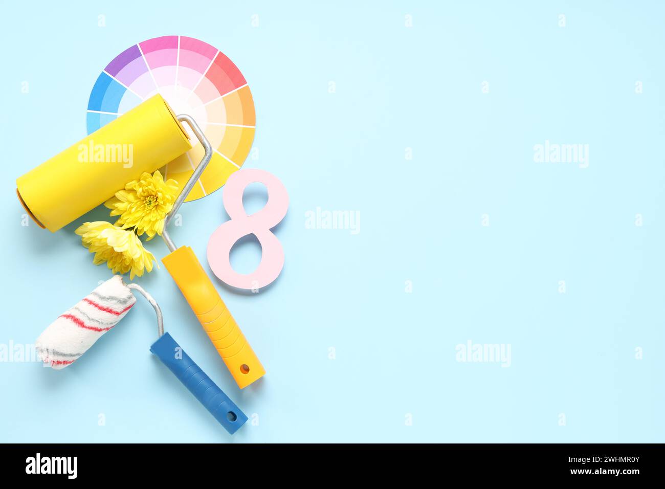 Composition with paint rollers, palette samples and flowers on color ...