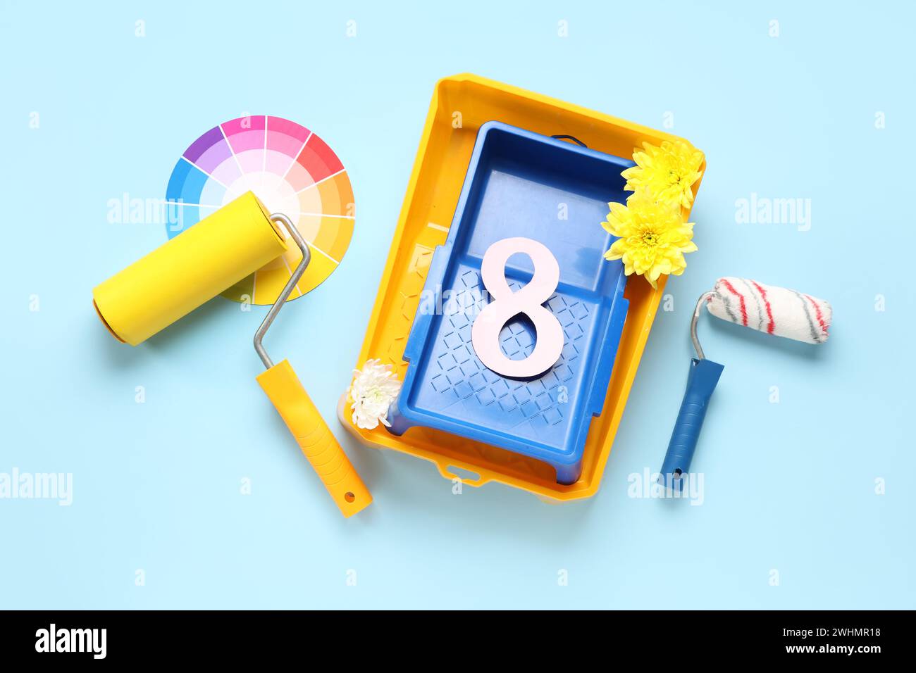 Composition with paint rollers, trays and paper figure 8 on color ...