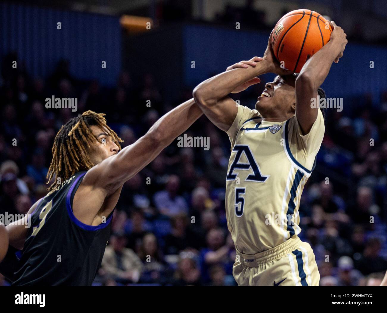 Akron guard Tavari Johnson (5) is fouled by James Madison forward T.J ...