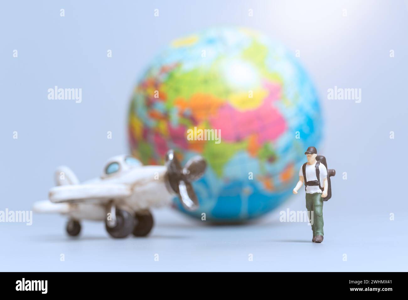 Miniature peopleT ravelers with airplane and globe Stock Photo - Alamy