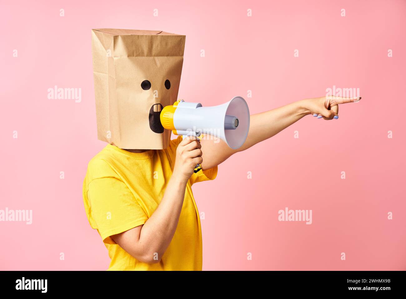 Anonymous female with paper bag on head screaming in megaphone and ...