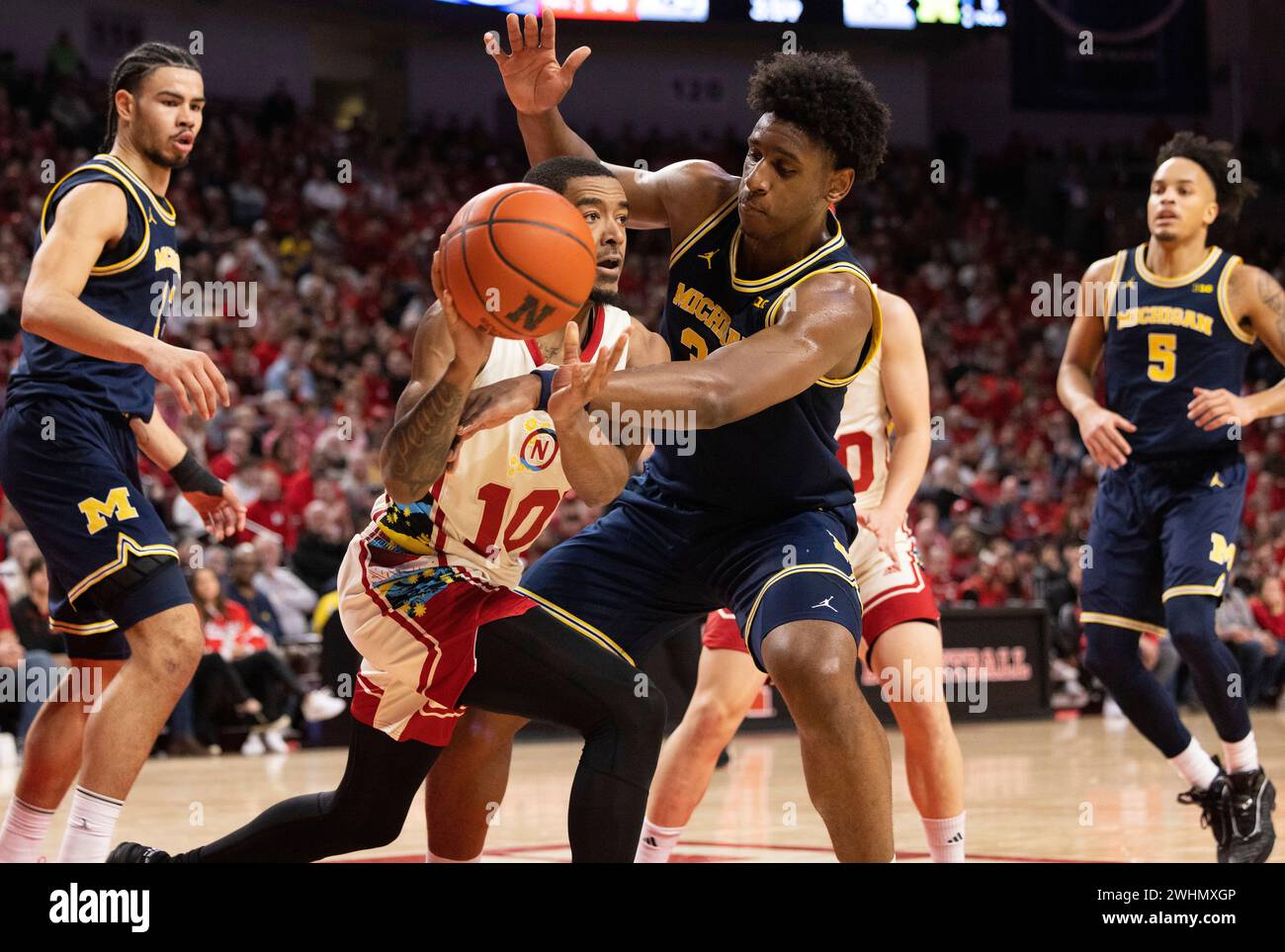 Nebraska's Jamarques Lawrence, center left, passes the ball around ...