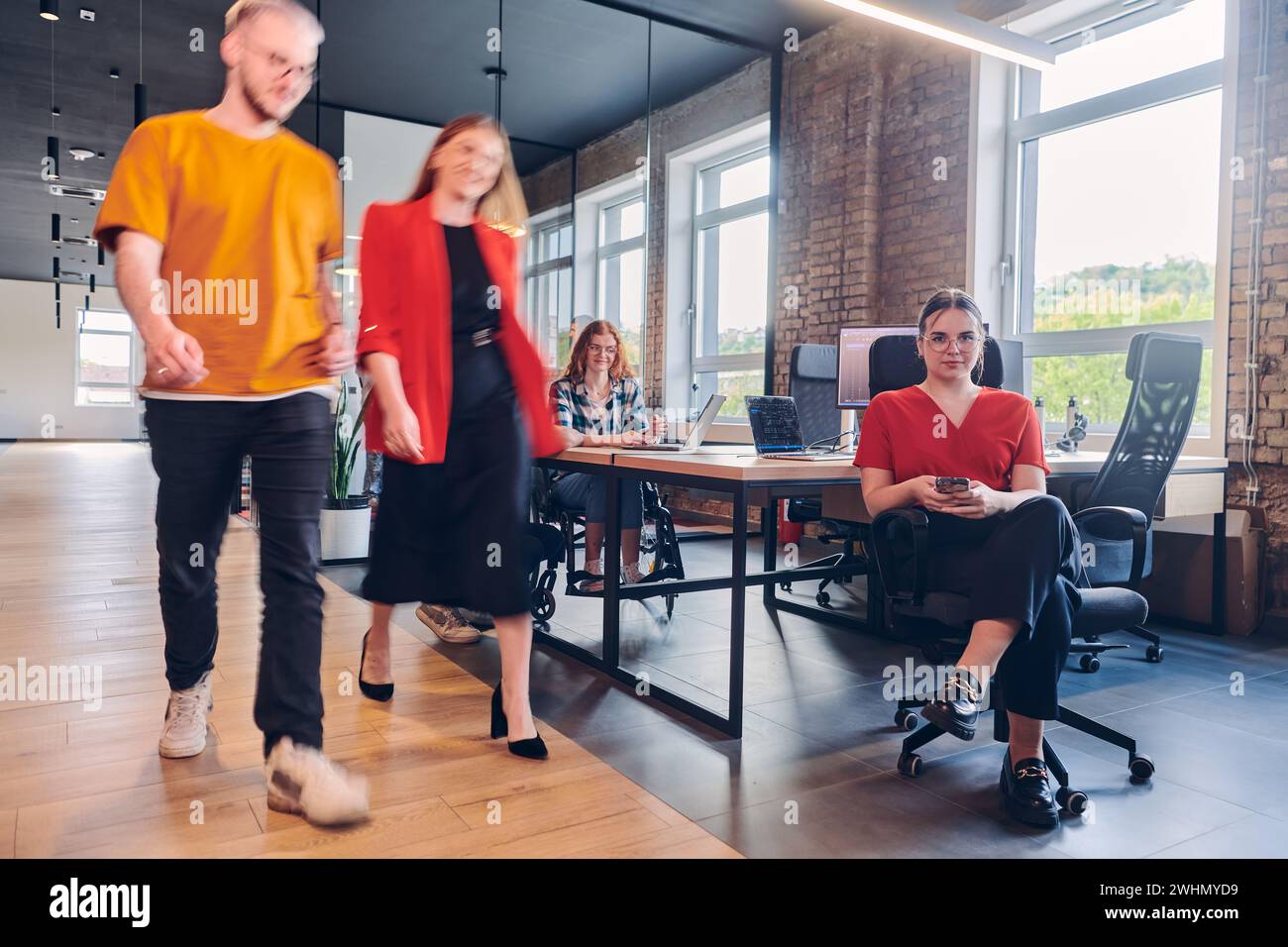 A diverse group of business professionals collaborates in a modern ...