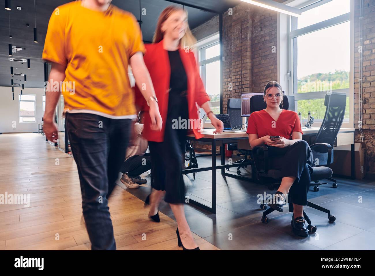 A diverse group of business professionals collaborates in a modern ...