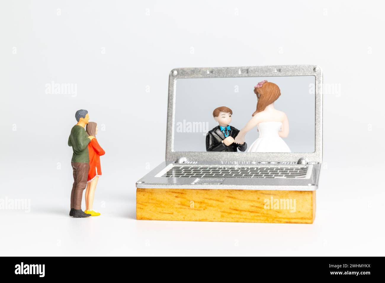 Miniature people Bride and groom virtual wedding on computer screen ...