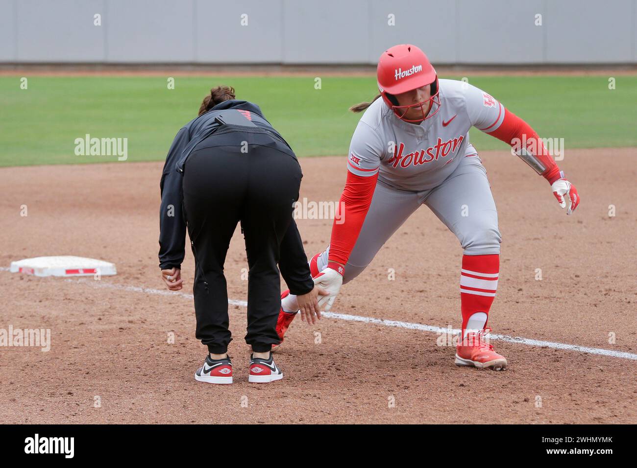Houston runner Bree Cantu, right, low fives head coach Kristin Vesely ...