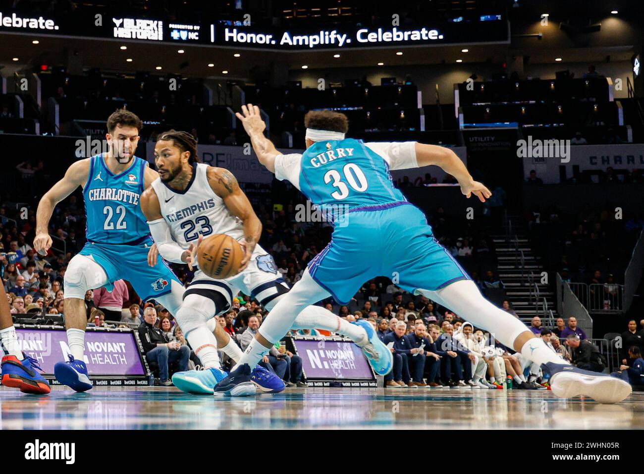 Memphis Grizzlies guard Derrick Rose (23) drives between Charlotte Hornets guards Vasilije Micic ...