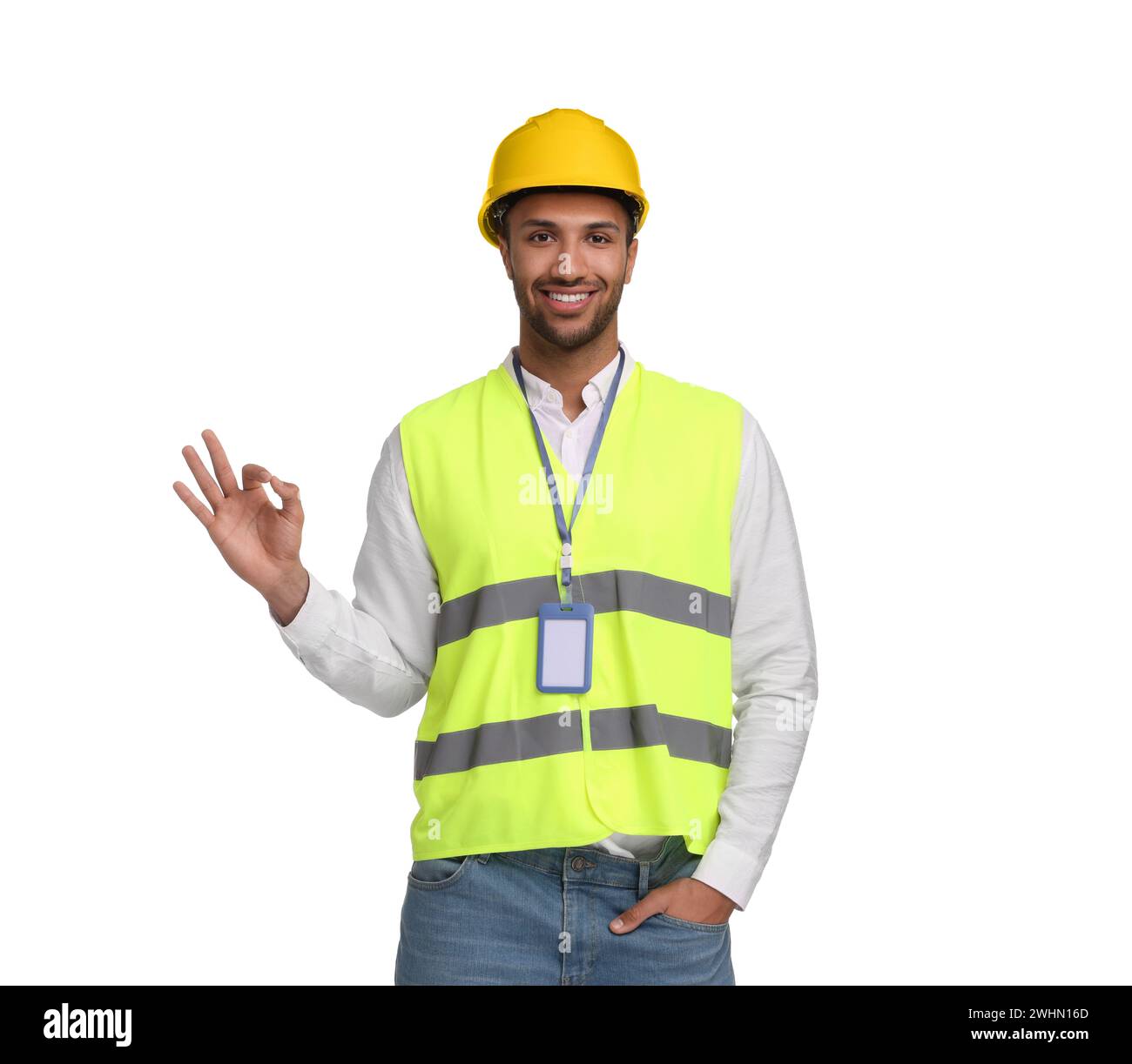 Engineer with hard hat and badge showing ok gesture on white background ...