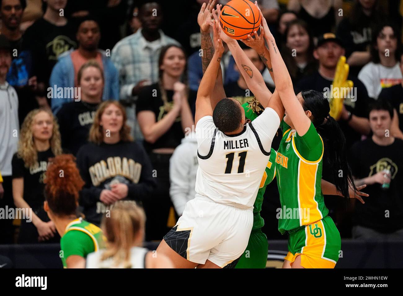 Colorado forward Quay Miller (11) shoots over Oregon forward Kennedy ...