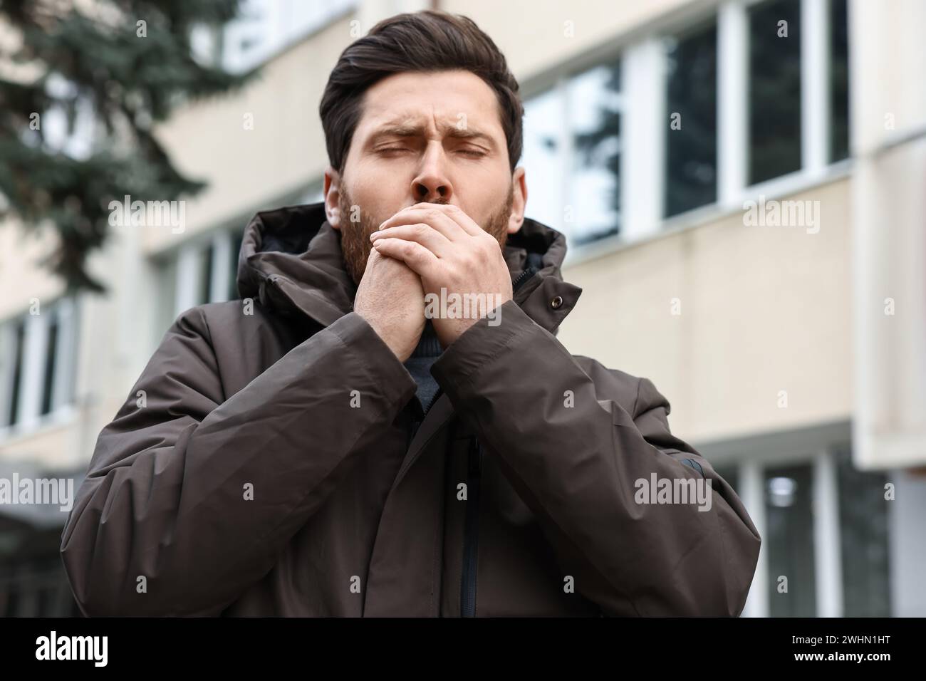 Sick man coughing on city street. Cold symptoms Stock Photo - Alamy
