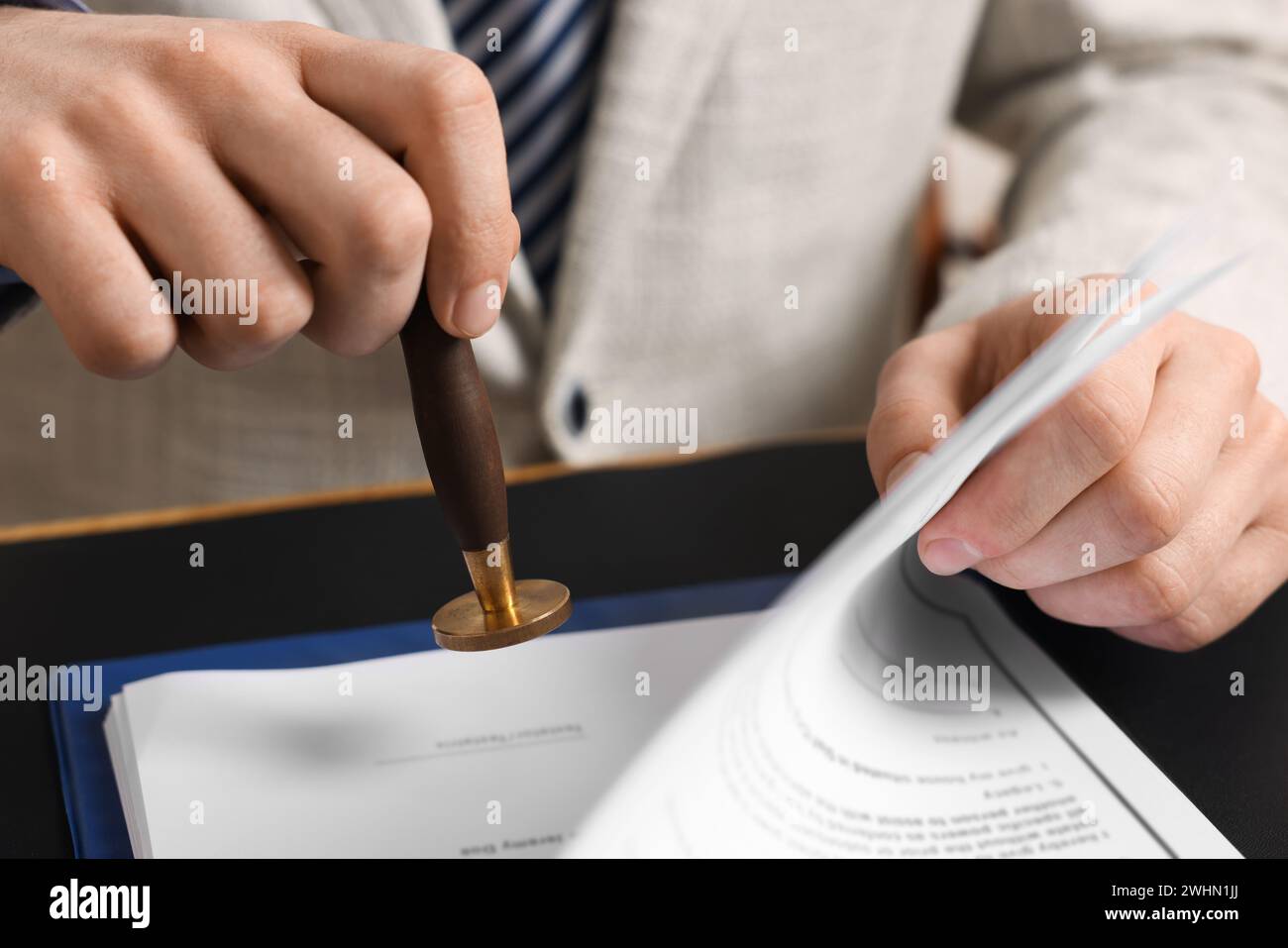 Notary stamping document at table, closeup view Stock Photo - Alamy