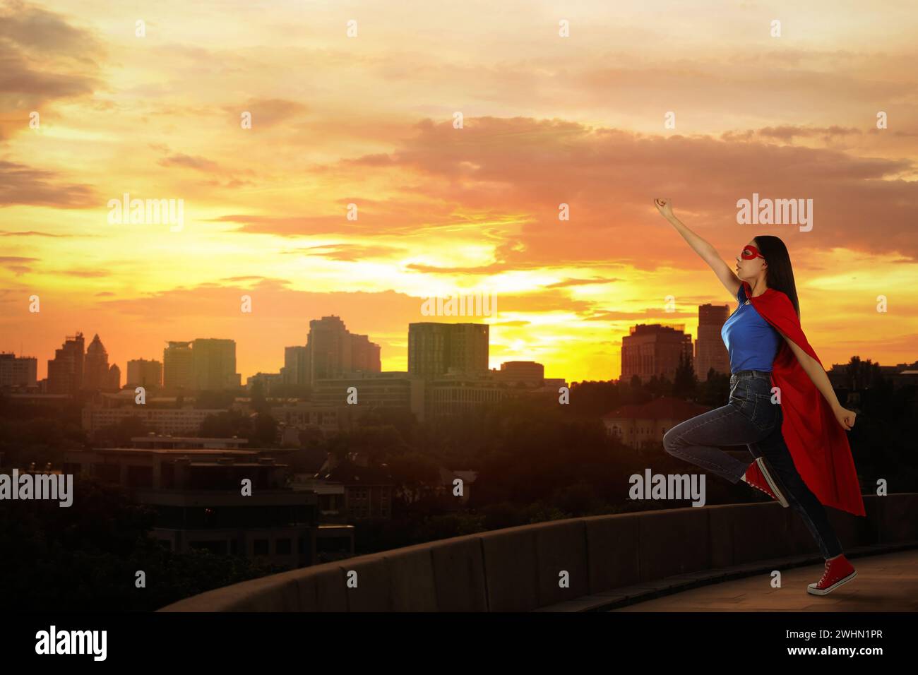 Superhero, motivation and power. Woman in cape and mask on high ...