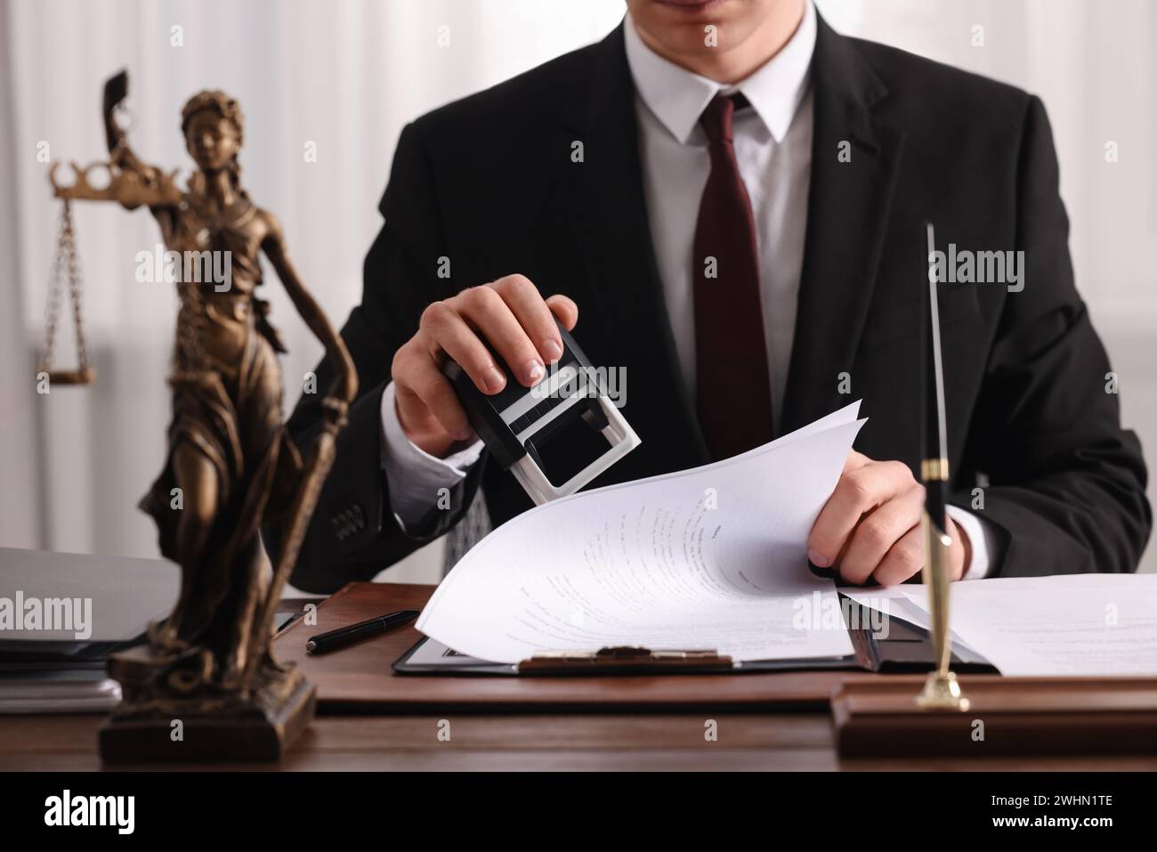 Notary stamping document at table in office, closeup Stock Photo - Alamy