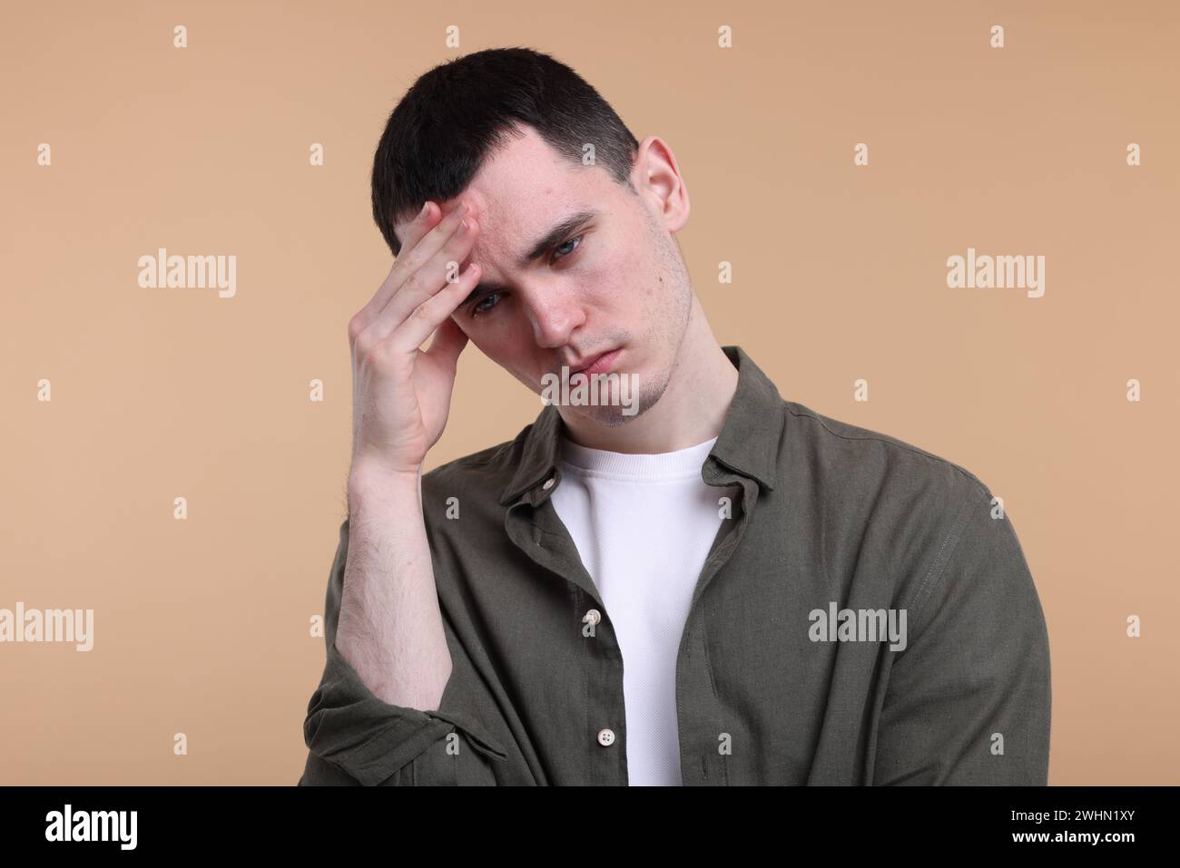 Portrait of sad man on beige background Stock Photo - Alamy