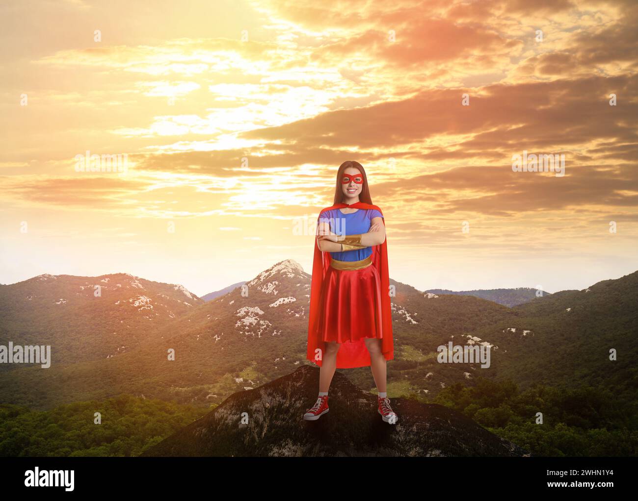 Superhero, motivation and power. Woman in cape and mask on high top in ...