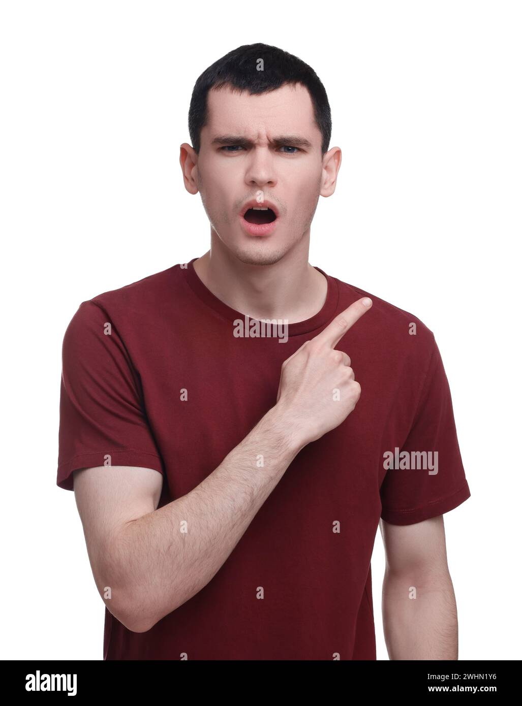 Surprised man pointing at something on white background Stock Photo - Alamy