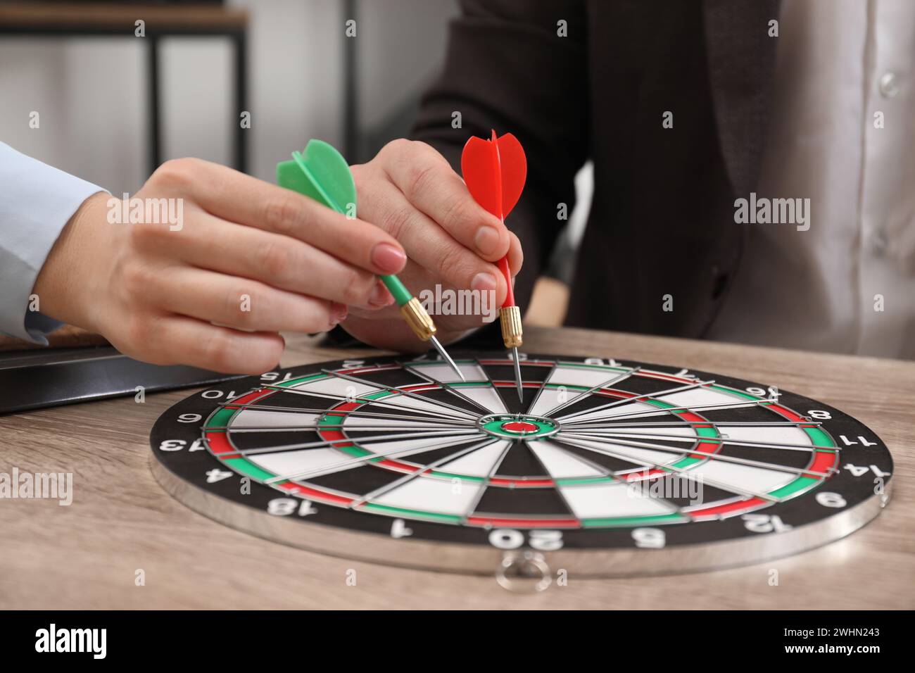 Business targeting concept. Man and woman with darts aiming at ...
