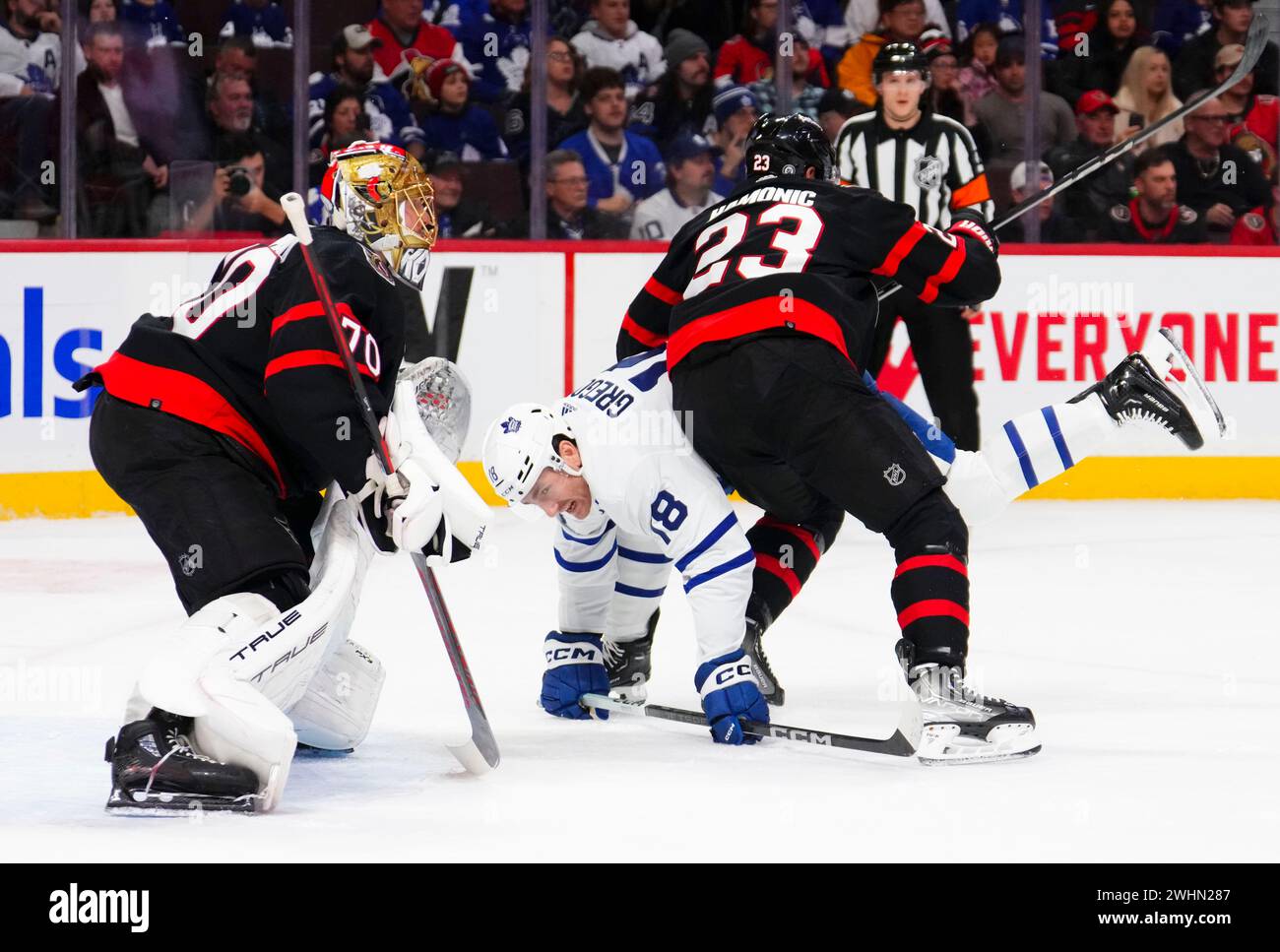 Ottawa Senators defenseman Travis Hamonic (23) upends Toronto Maple ...