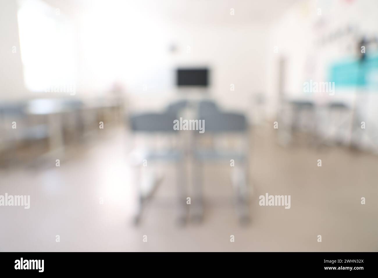 Blurred view of empty school classroom with desks and chairs Stock ...