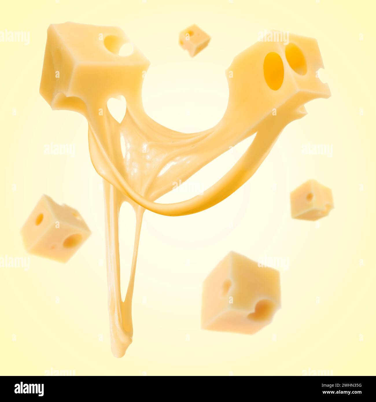 Pieces of cheese falling on yellow background Stock Photo - Alamy