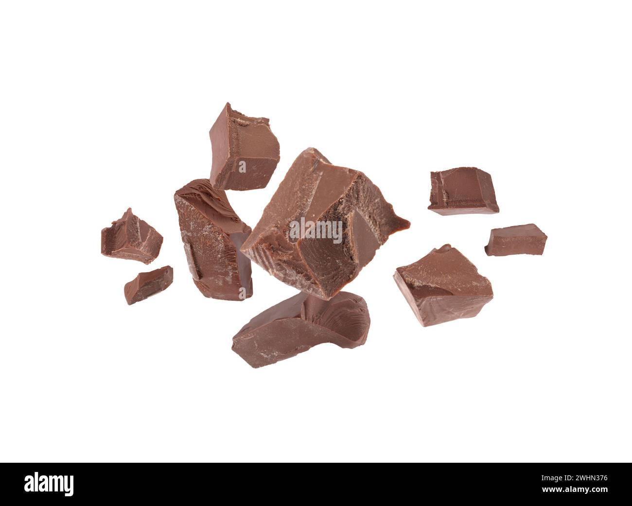 Tasty chocolate chunks falling on white background Stock Photo - Alamy