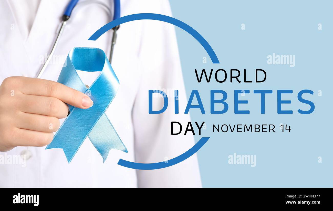World Diabetes Day. Doctor holding light blue ribbon on color ...