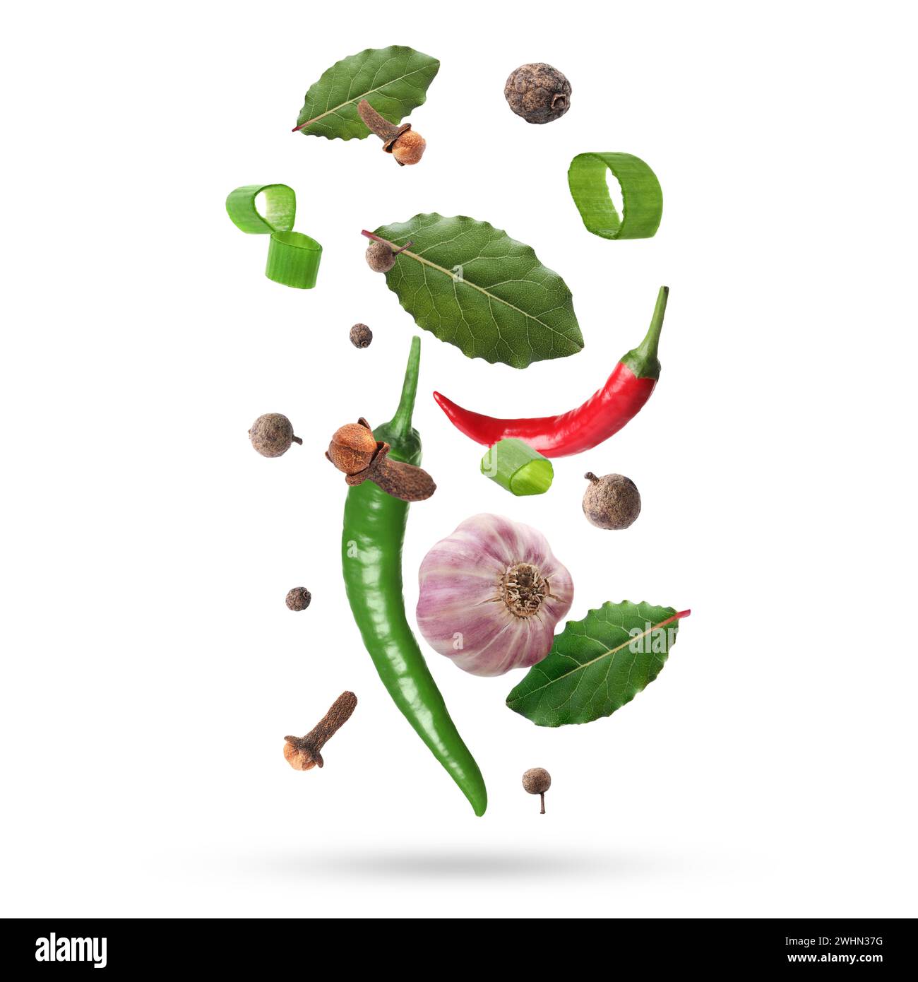 Different aromatic spices falling on white background Stock Photo - Alamy