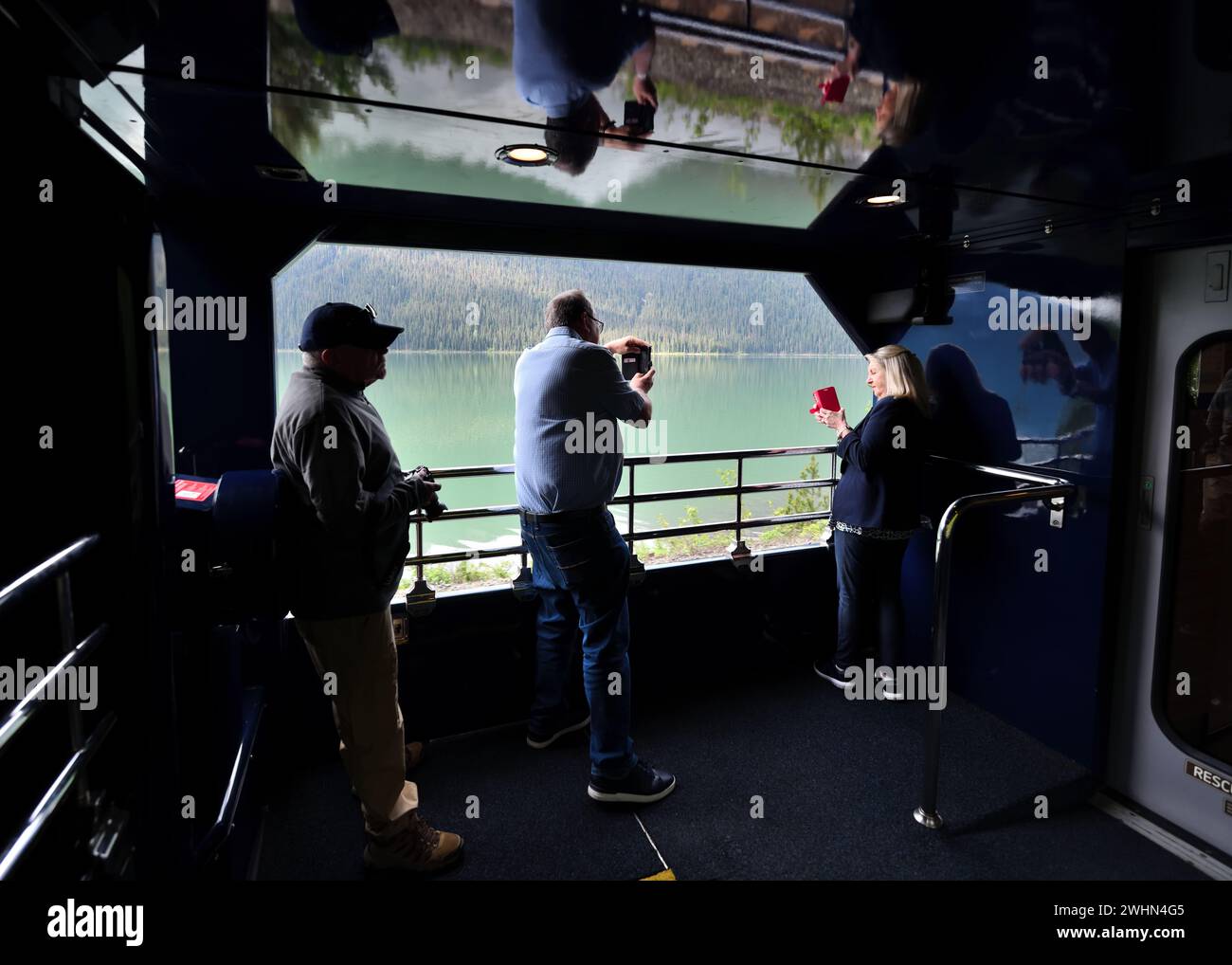 People taking pictures on the Open air carriage on the Rocky ...