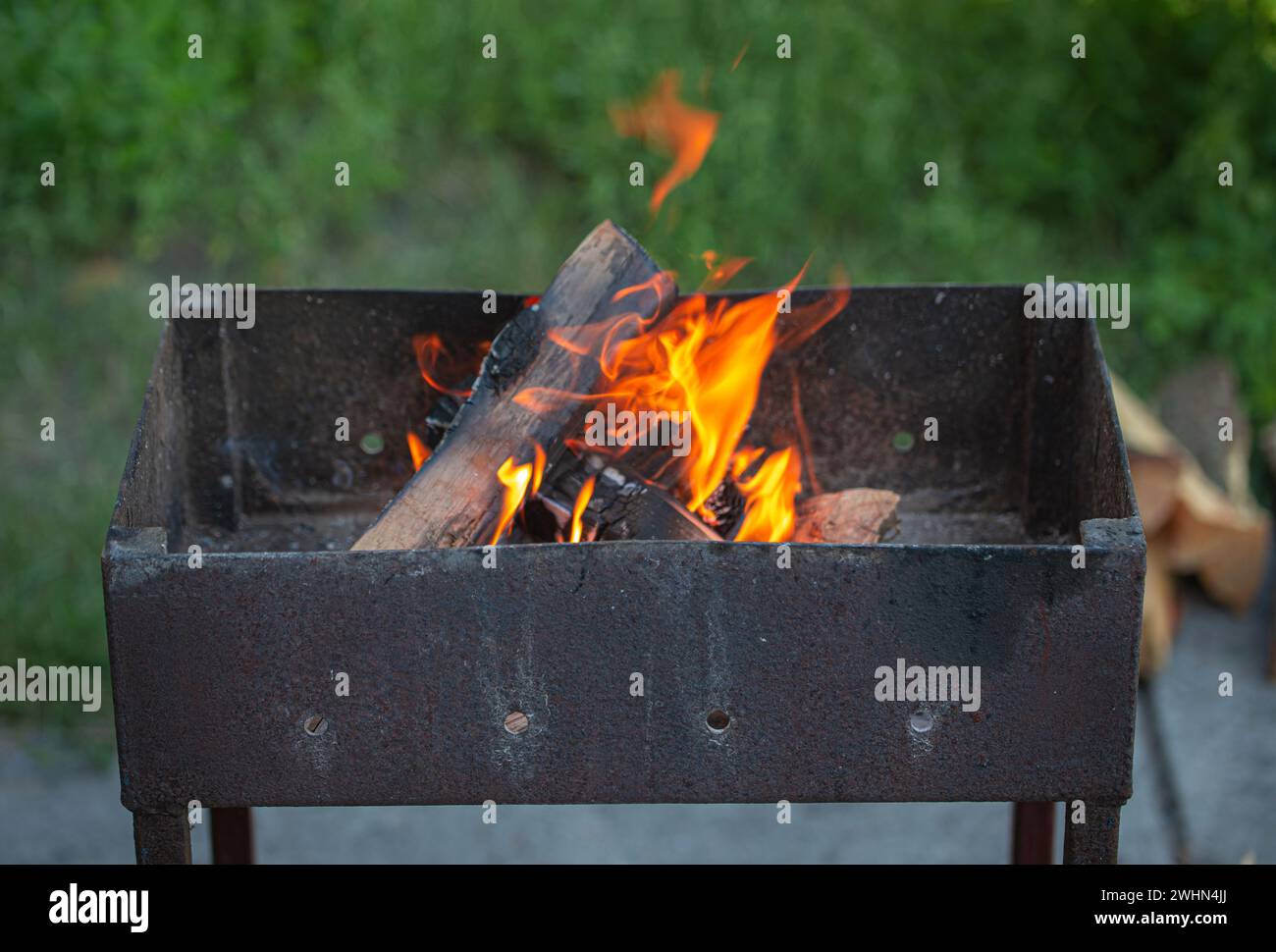 Open Air Rustic Metal Barbecue Grill with Firewood. Fire flame for BBQ ...