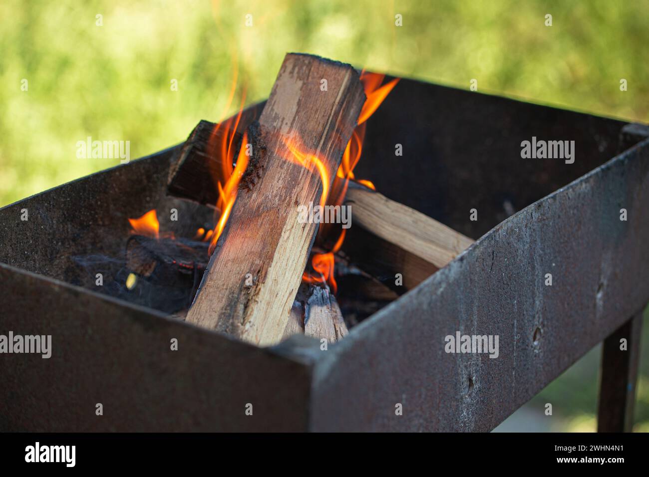 Open Air Rustic Metal Barbecue Grill with Firewood. Fire flame for BBQ ...